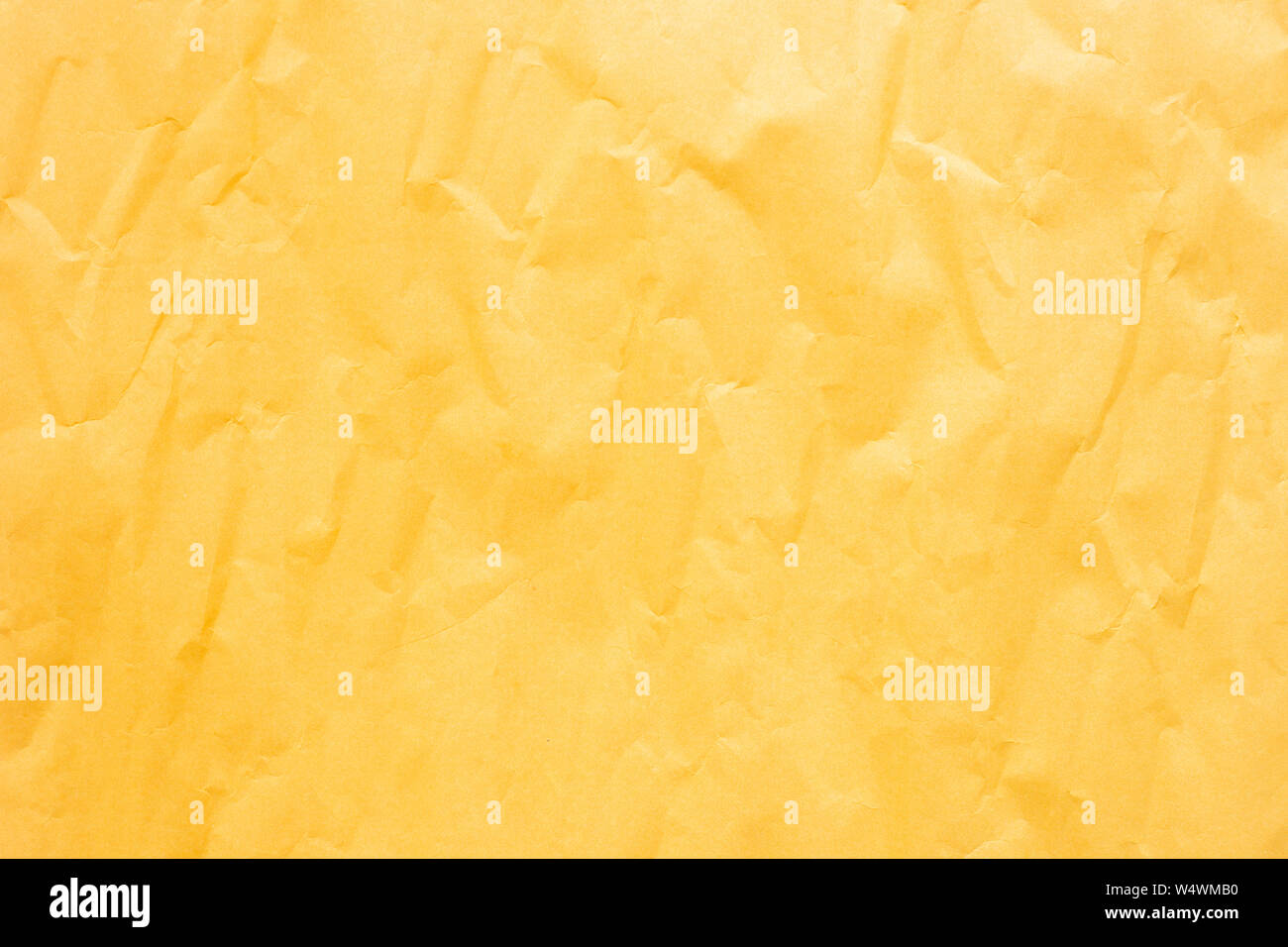 Gold yellow crumpled paper for background Stock Photo - Alamy