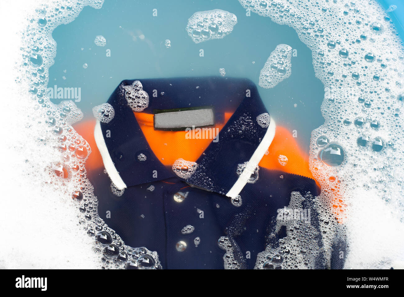 Polo shirt soak in powder detergent water dissolution, washing cloth ...