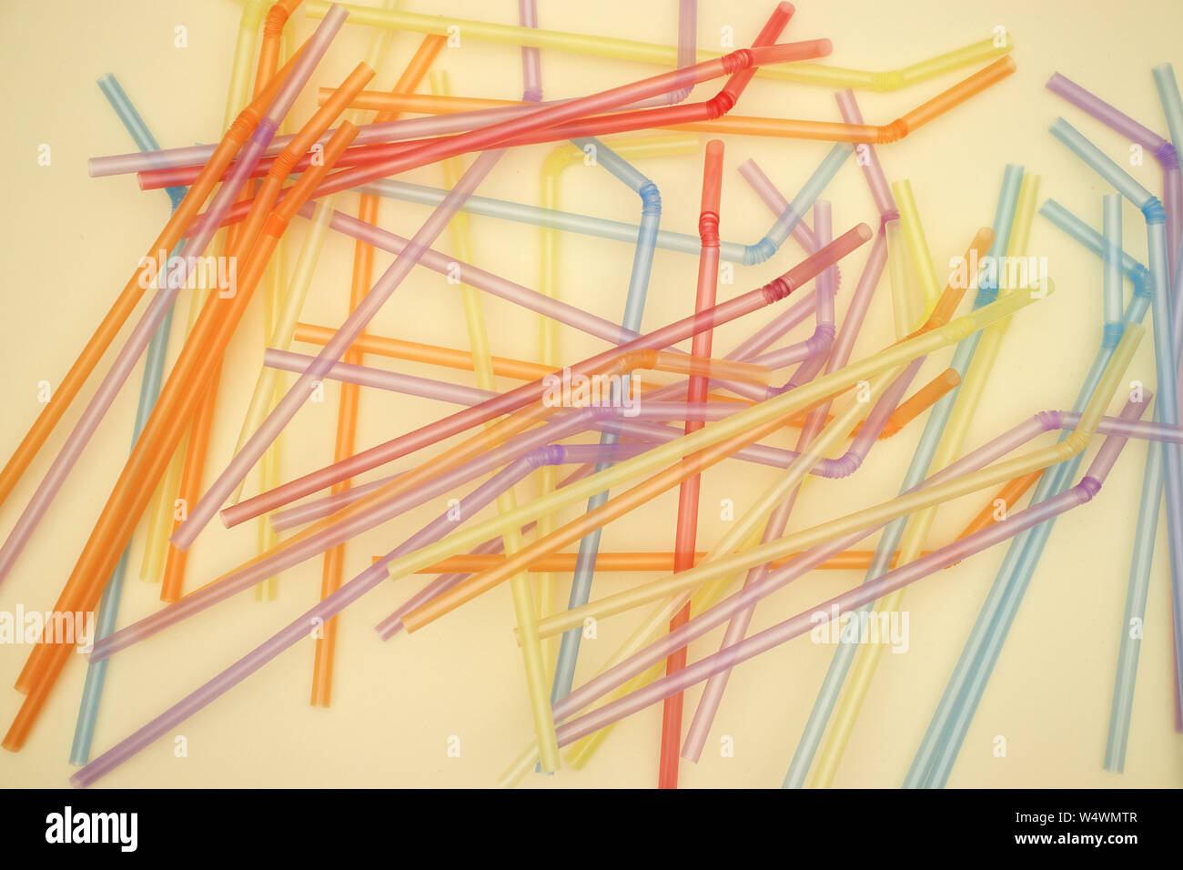 Colorful plastic tube on yellow background Stock Photo - Alamy