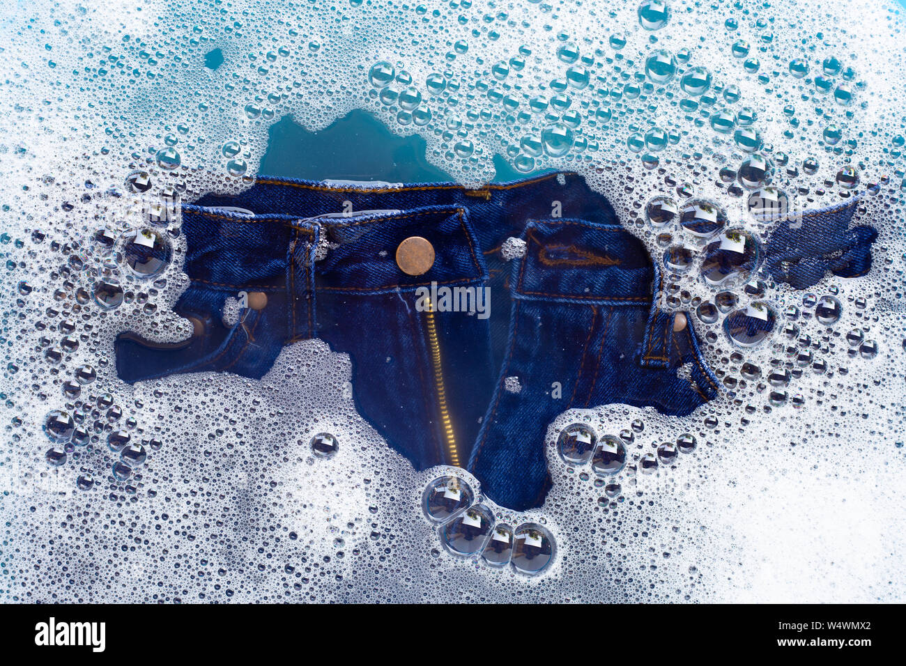 Jeans soak in powder detergent water dissolution, washing cloth ...