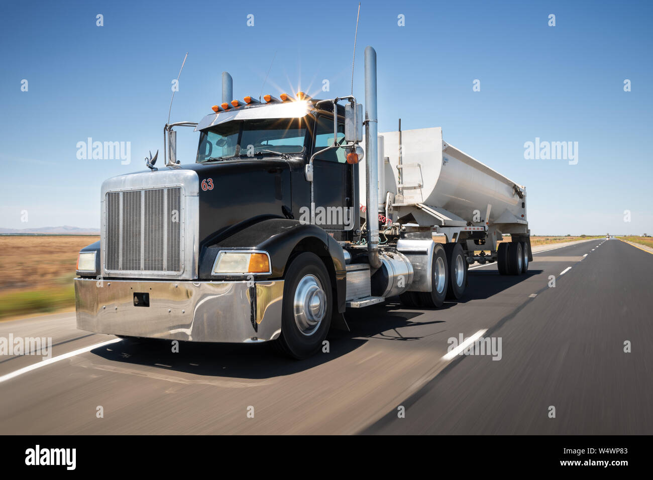Moving big black truck on the highway in California, United States ...