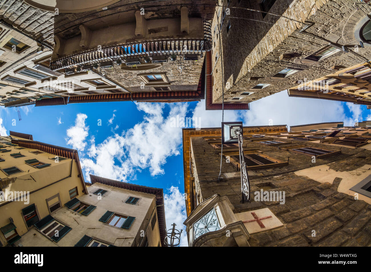 FLORENCE, ITALY - MAY 12, 2019: View up among buildings at a narrow ...