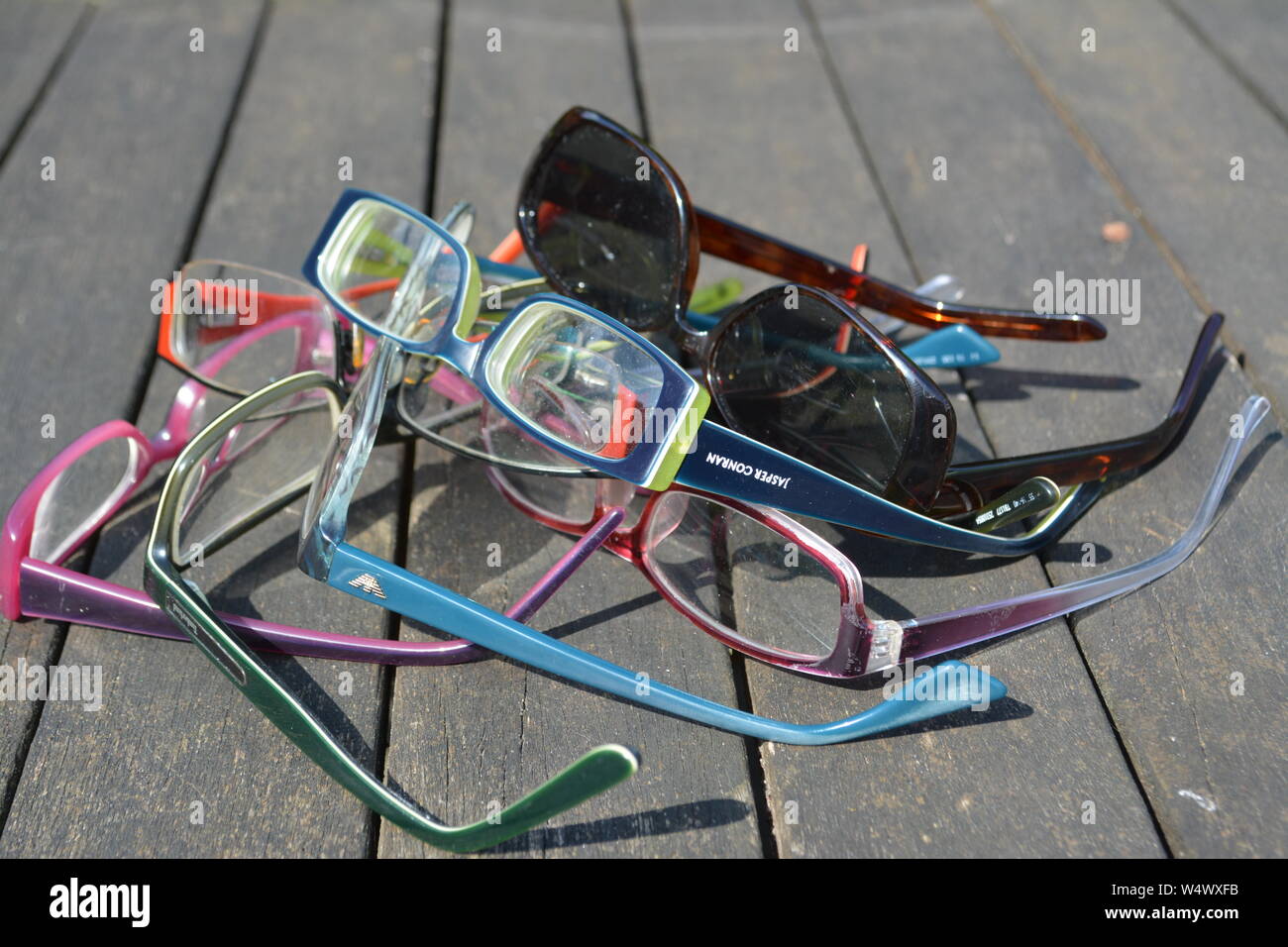 Large number of different framed unfolded spectacles glasses arranged ...
