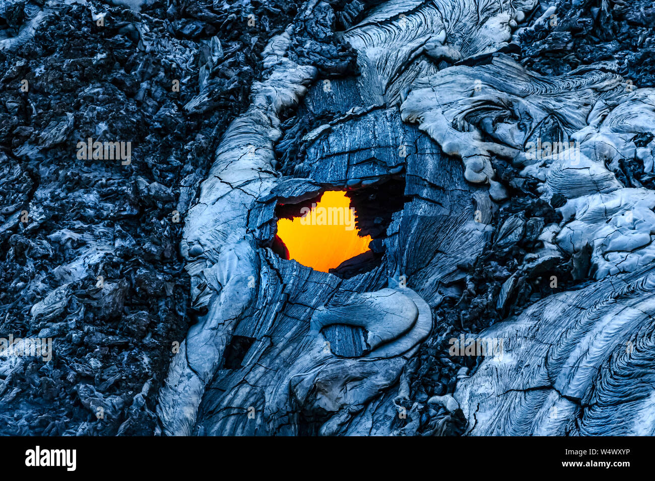 Hot lava flowing fast through an underground lava tube Stock Photo - Alamy