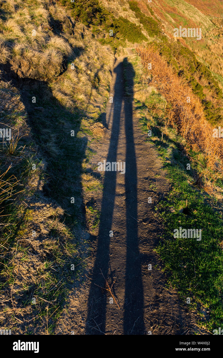 Shadow of a walker - photographer near sunset, on a footpath below ...