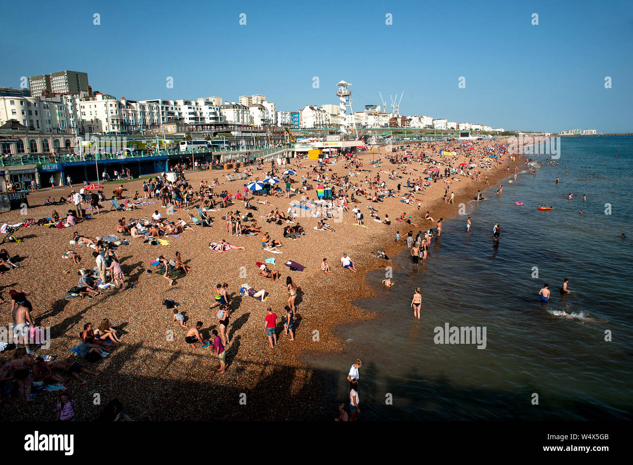 Brighton beach, Sussex, England, July 2019. People flock to the beach ...