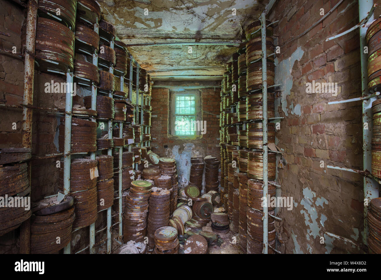 Destroyed from time to time storage room with stored old rusty round ...