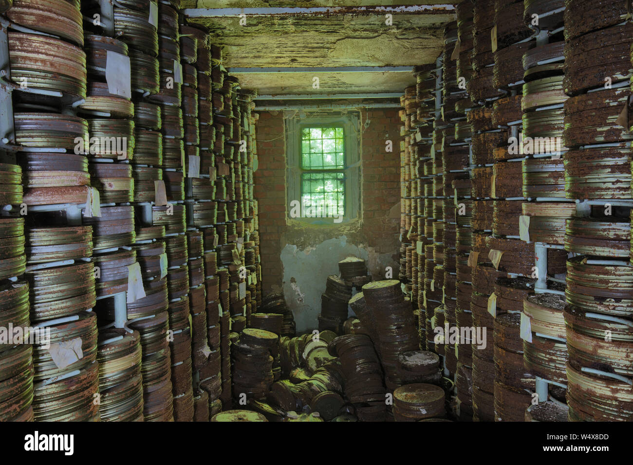 Destroyed from time to time storage room with stored old rusty round ...