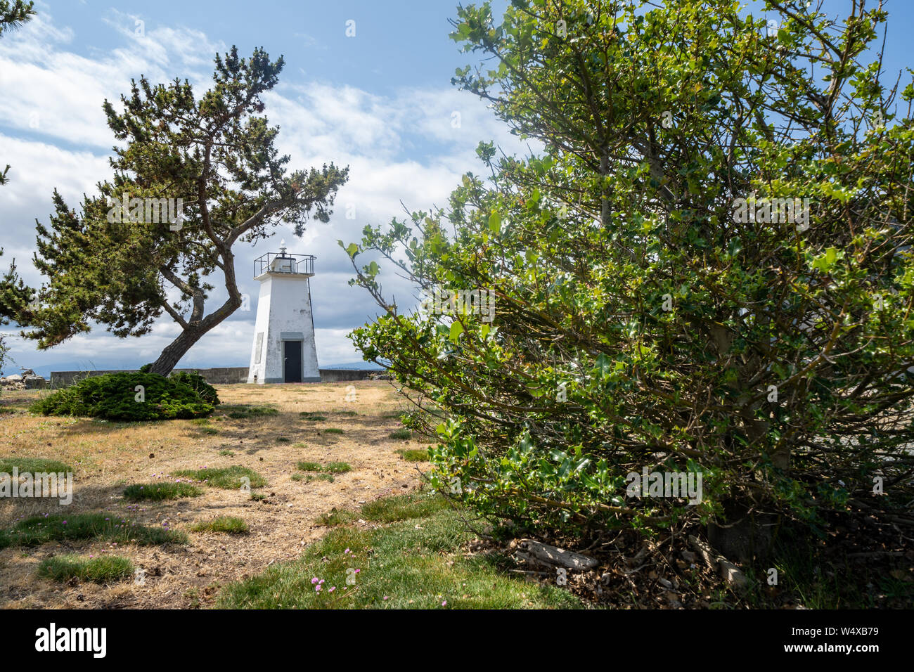 Bush Point Lighthouse, with trees framing the nautical structure on a ...