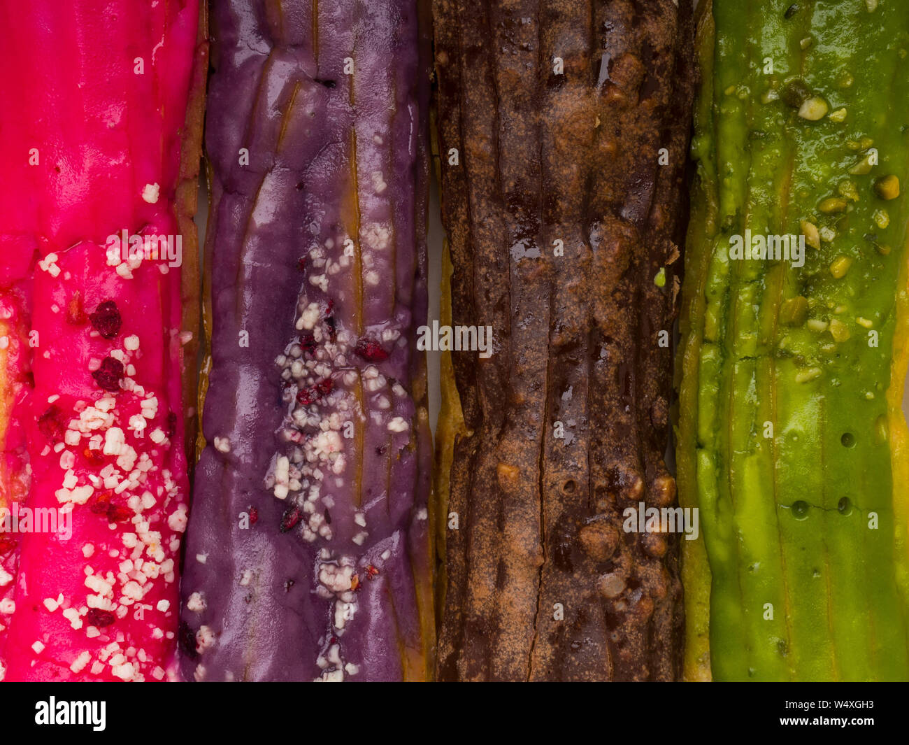 colorful eclairs background, pink with berry, green with pistachios ...