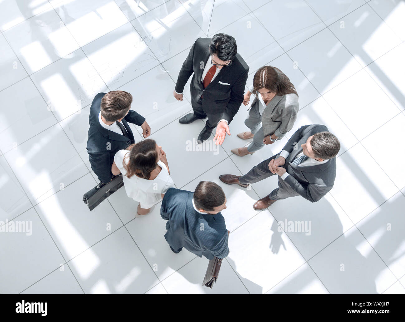 top view. employees standing in a modern office Stock Photo - Alamy