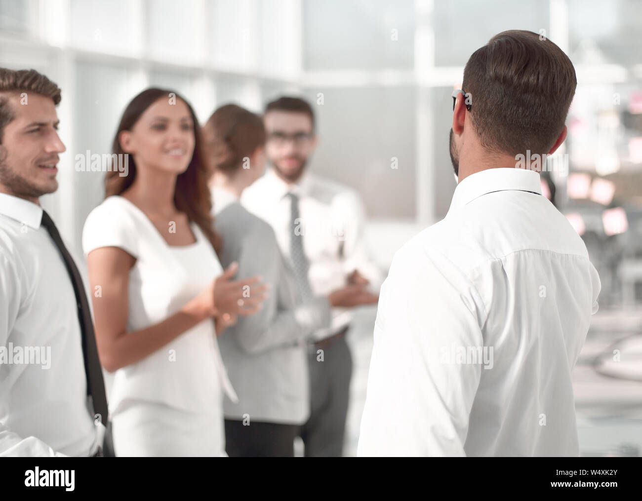 rear view.Manager standing in a modern office Stock Photo - Alamy