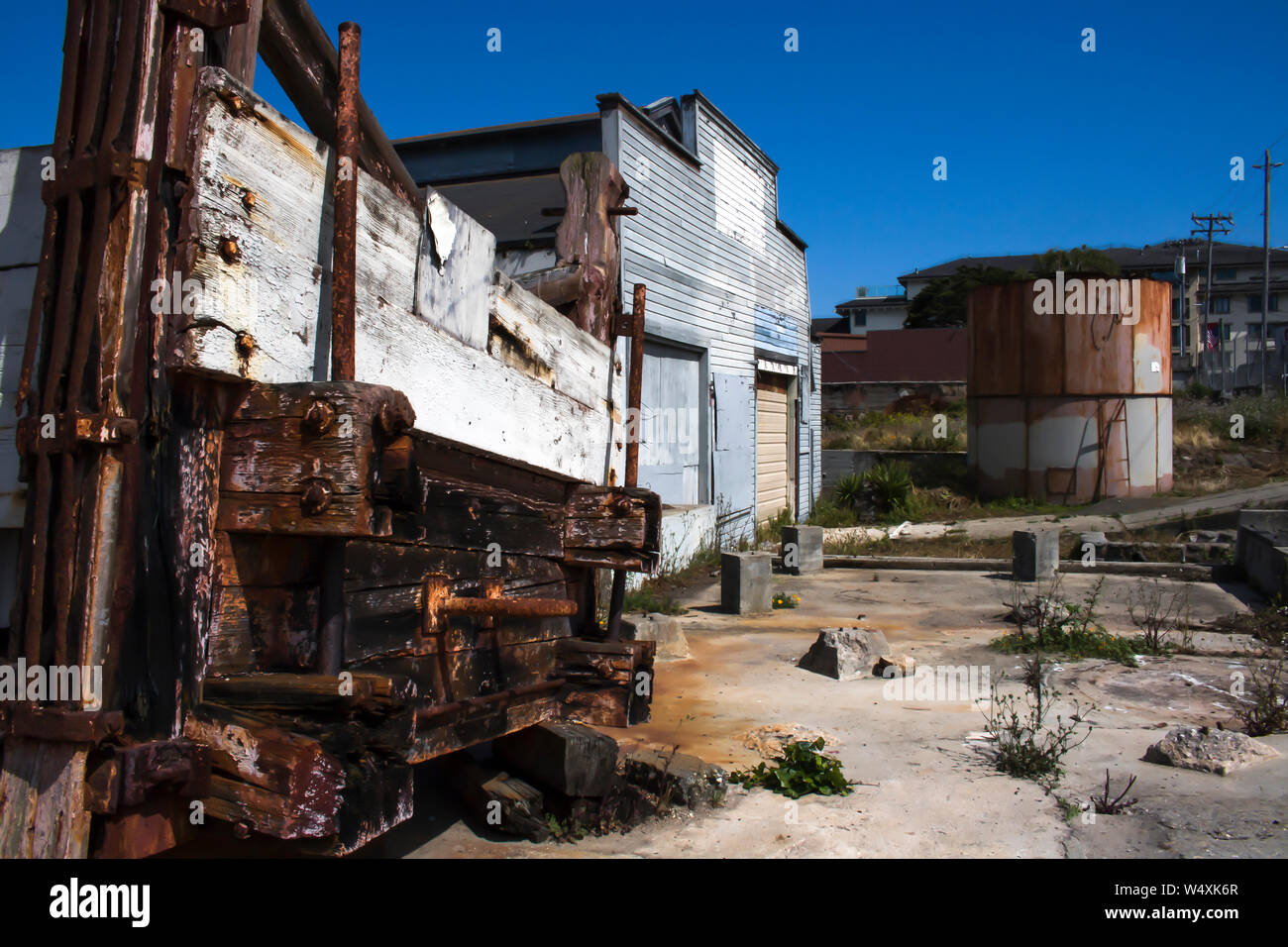 Old historic abandoned cannery building and fish hopper and tank on ...