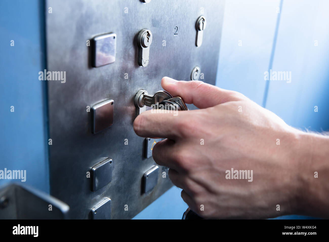 Close-up Of Human Hand Inserting And Turning The Key To Unlock Elevator ...