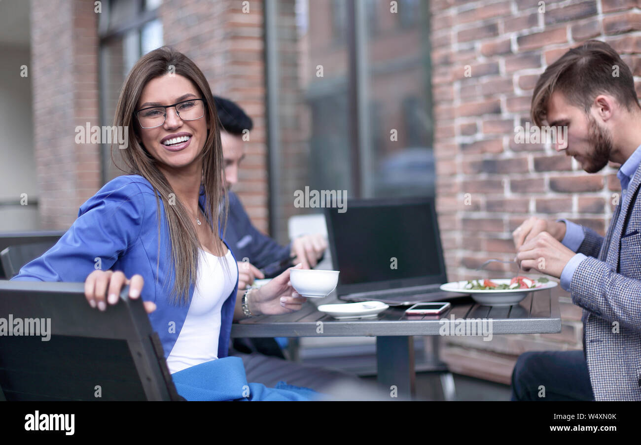 employees sitting at a table in a cafe Stock Photo - Alamy