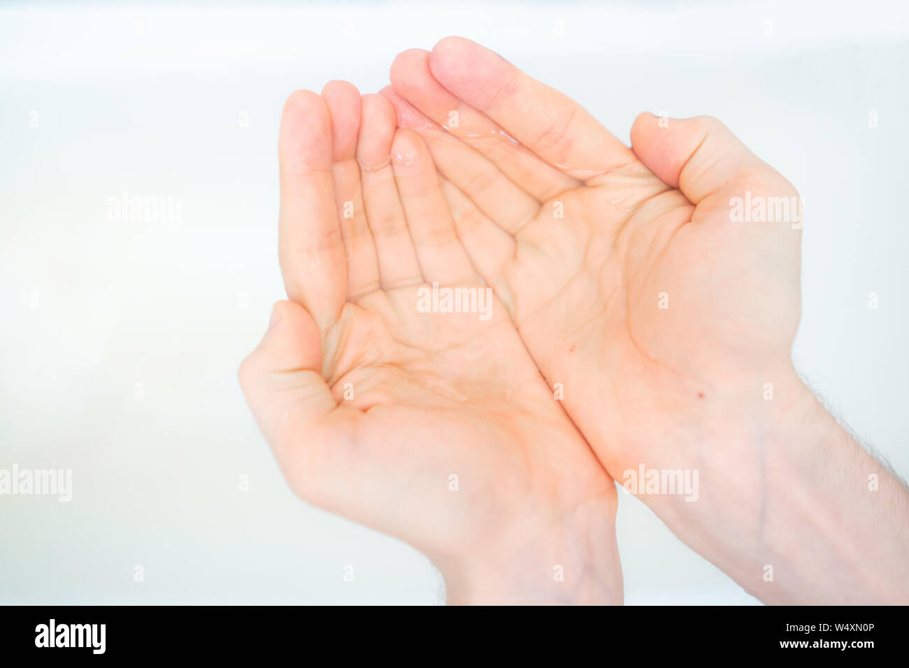 cupped hands with pure water, eco natural resources concept Stock Photo ...