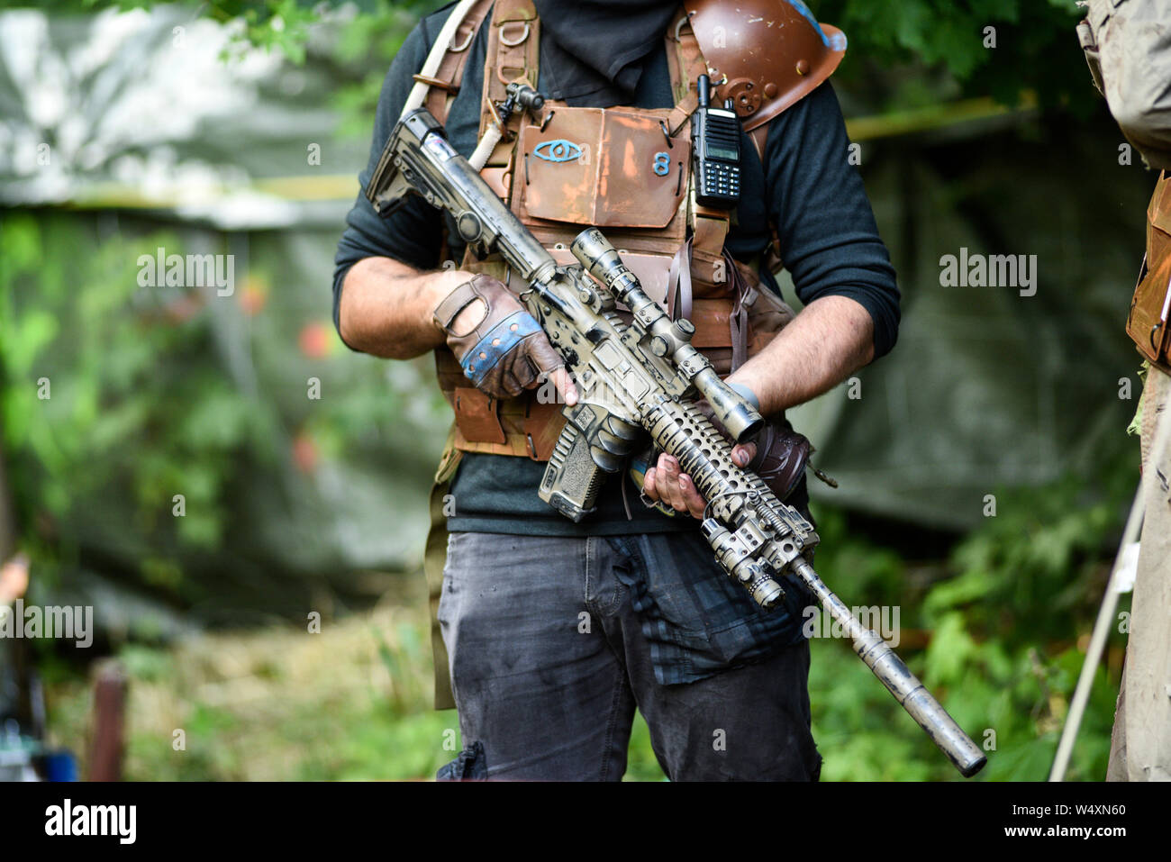 A man holding a rifle in pos apocalyptic world Stock Photo - Alamy