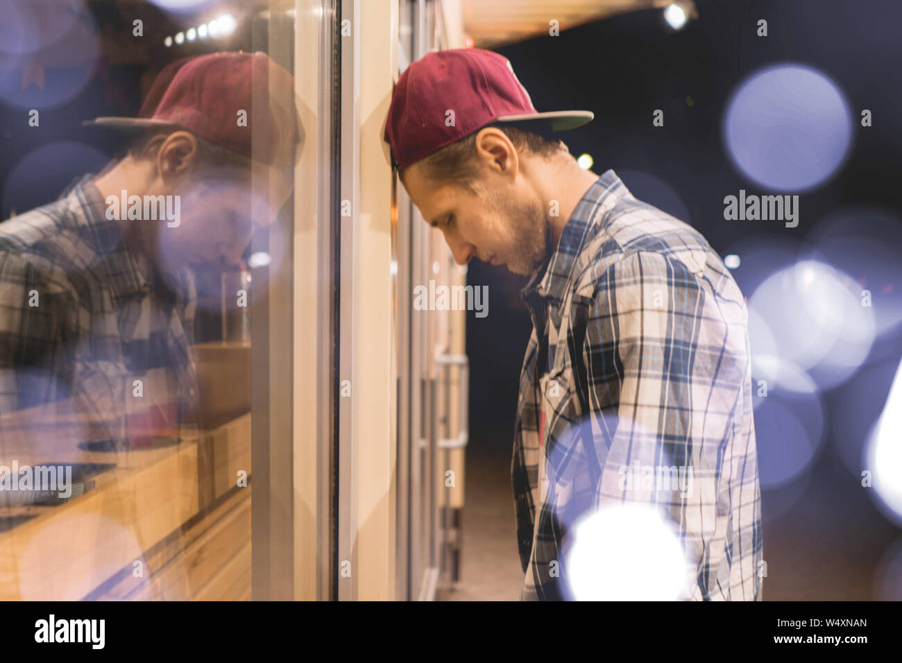disappointed sad desperate young man lean head on the wall in the city ...