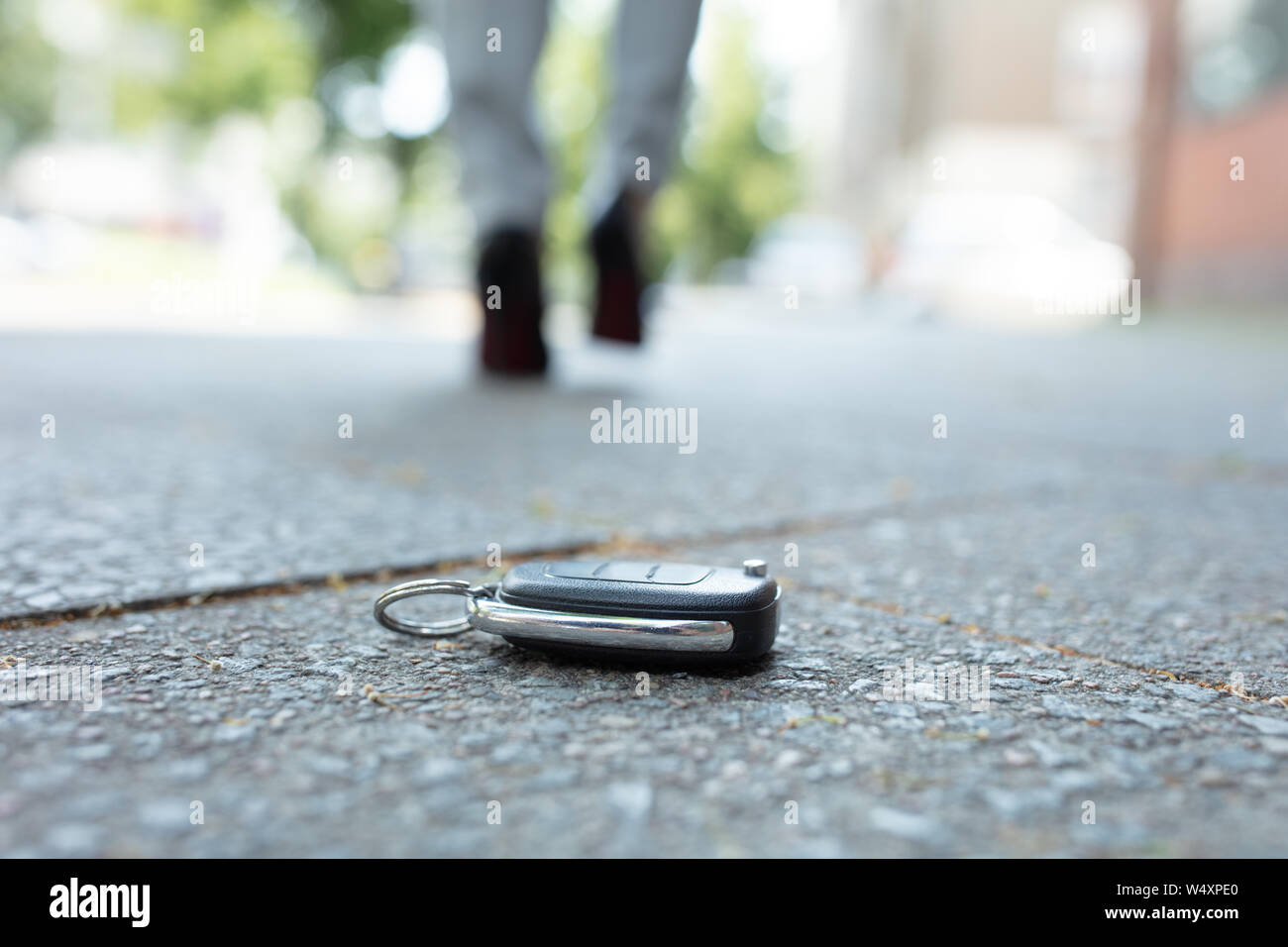 A Woman Walking After Losing Her Car Key On Street Stock Photo - Alamy
