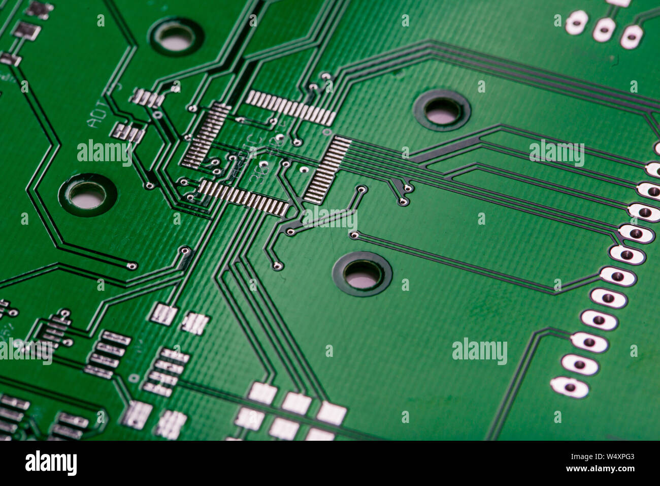 Printed green computer circuit board with many electrical components ...