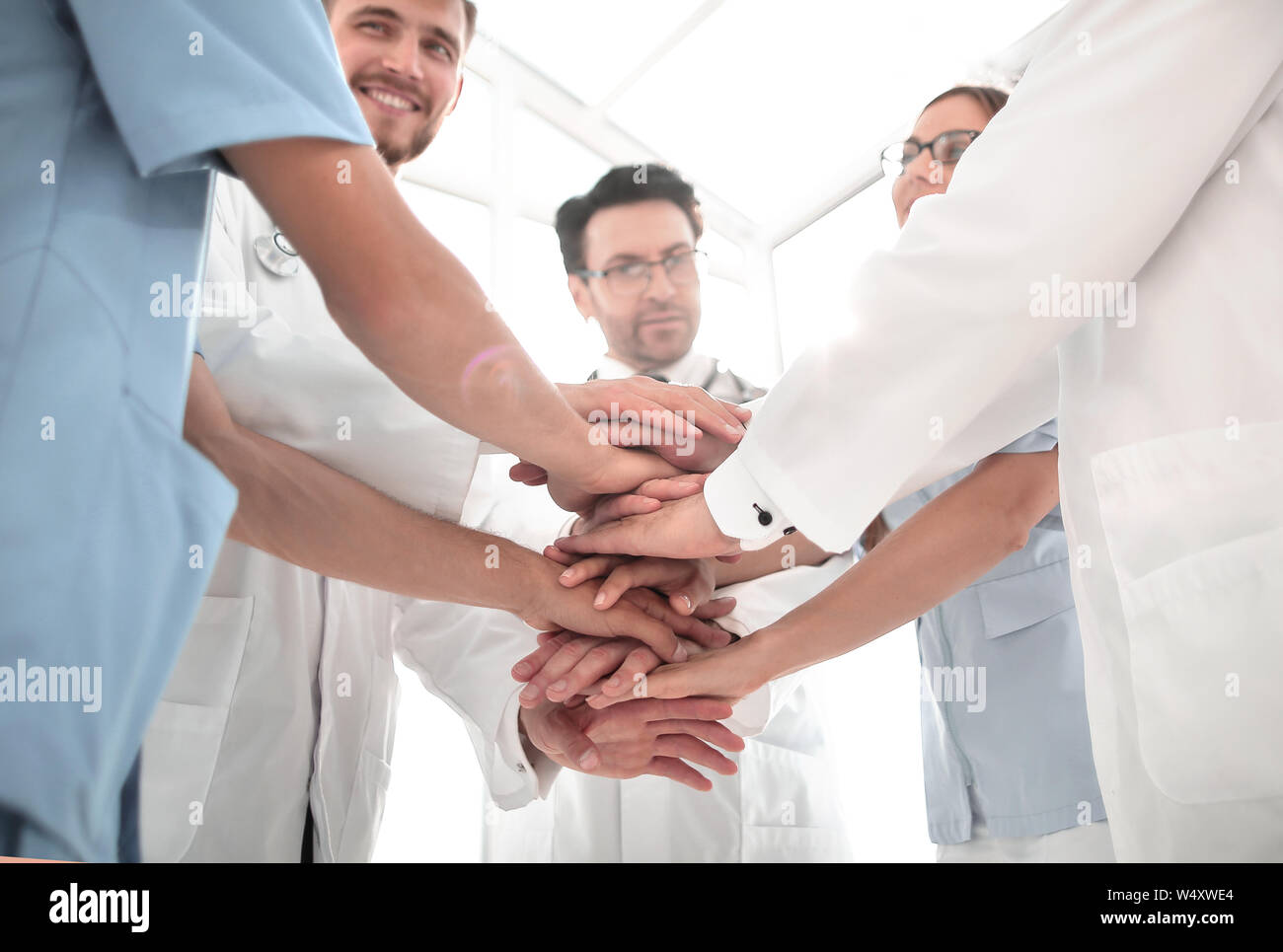 group of doctors with their hands folded together Stock Photo - Alamy