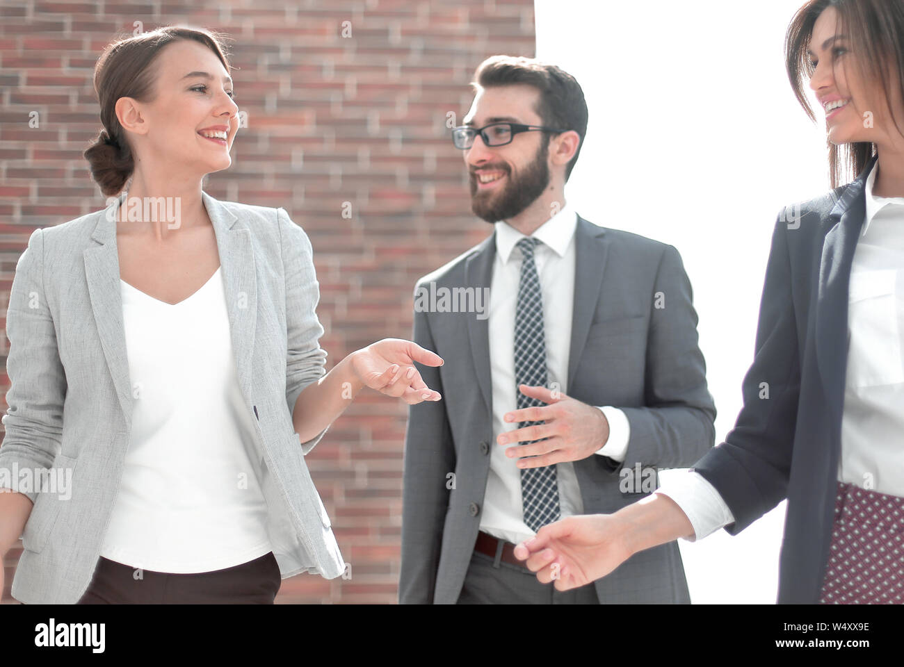 group of employees on the background of the office Stock Photo - Alamy