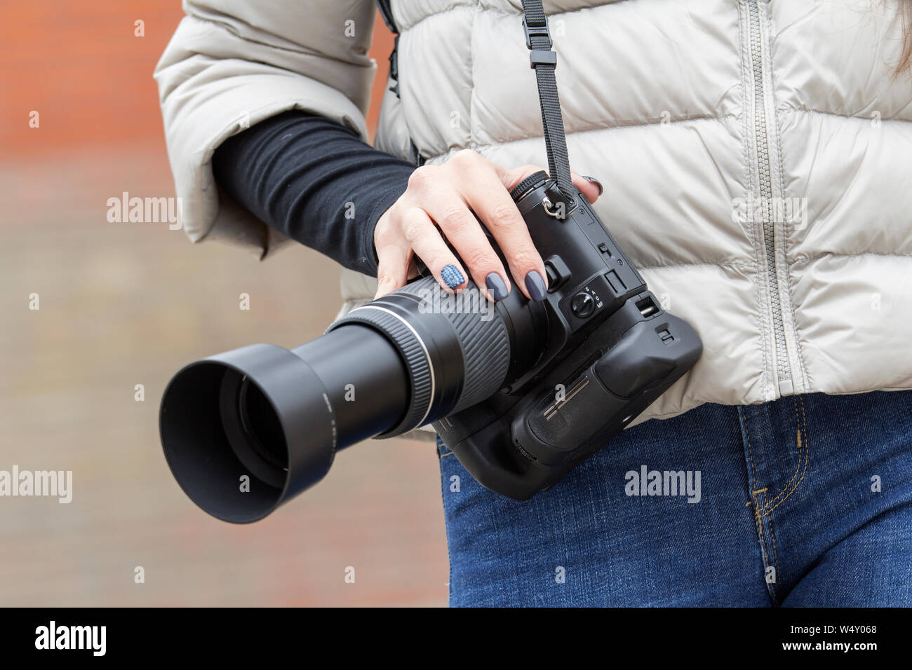 SLR camera hanging around my neck at the photographer Stock Photo - Alamy