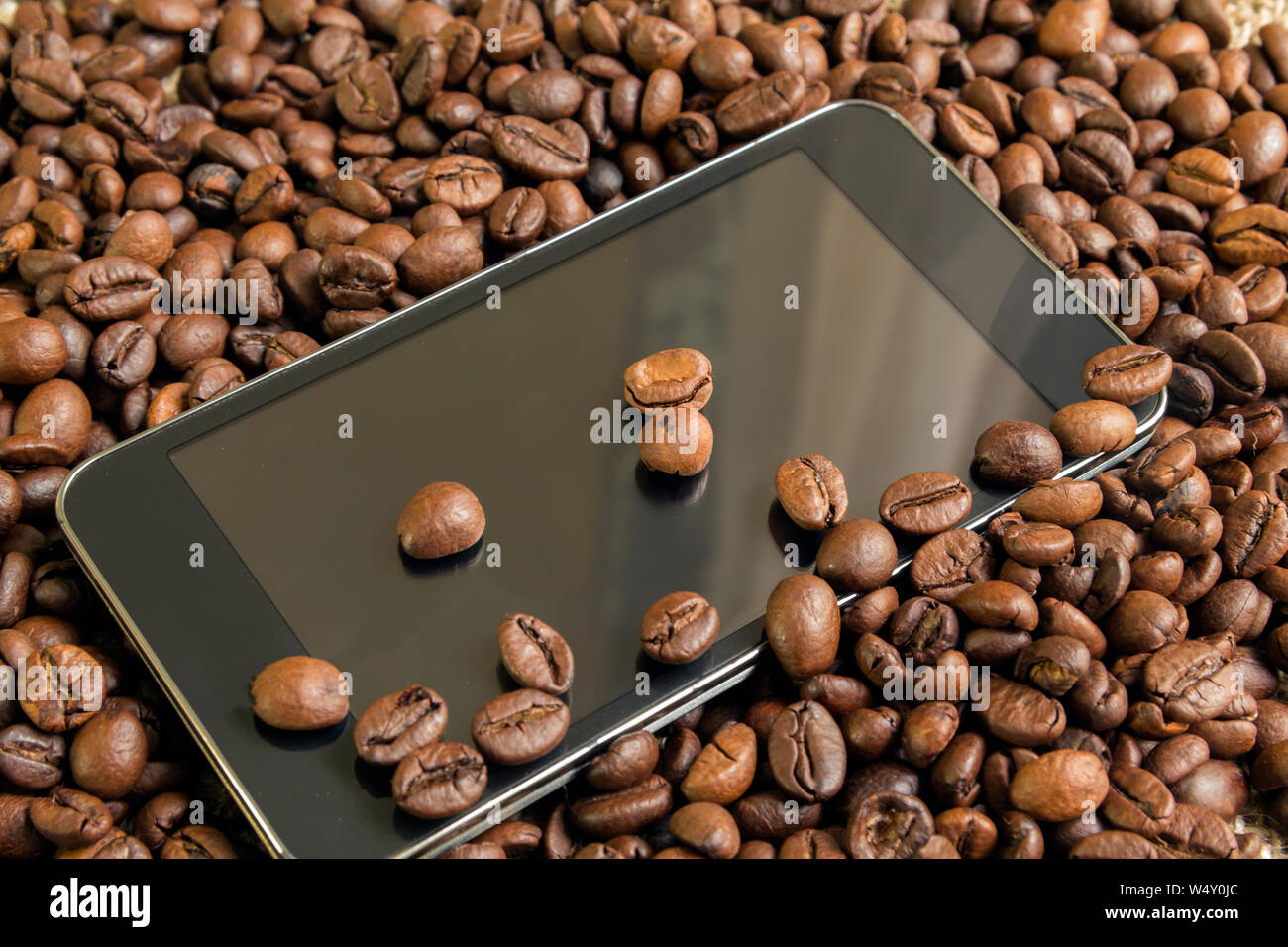 mobile phone in the coffee roasted beans background Stock Photo - Alamy