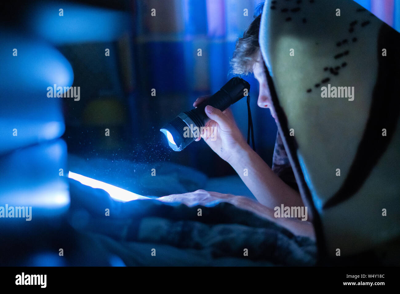 Reading book at night with a torch hi-res stock photography and images ...