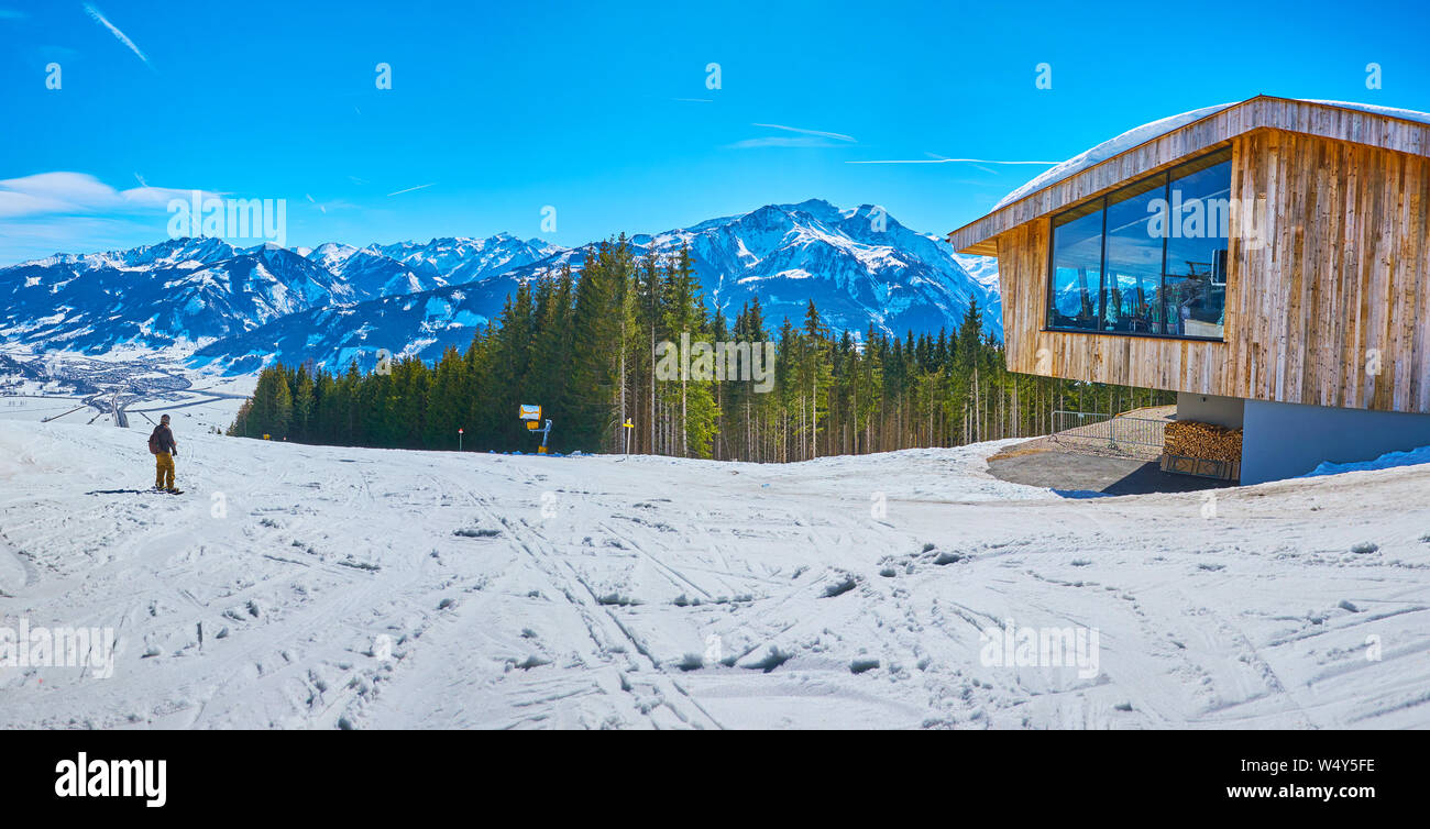 Panorama of snowbound Areitalm Alpine meadow with groomed piste, old ...