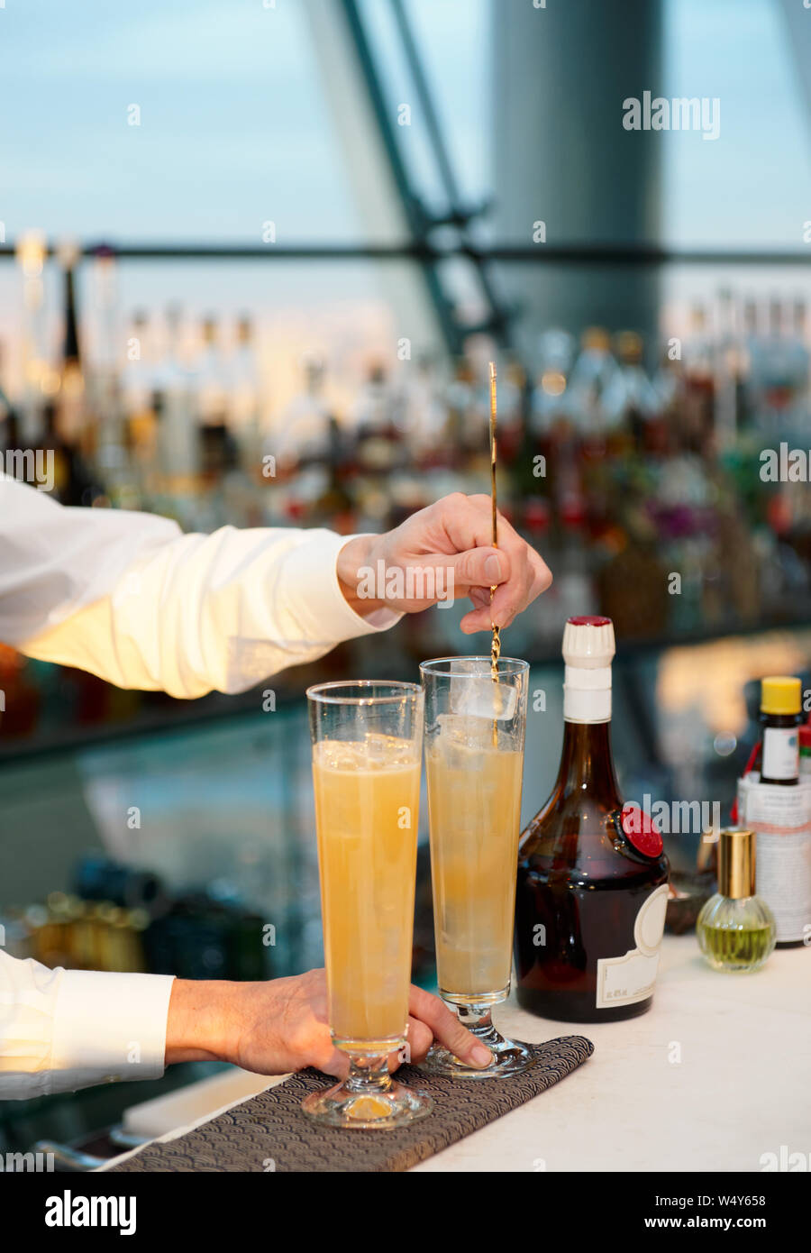 Bartender is stirring a cocktail, sunset light Stock Photo - Alamy
