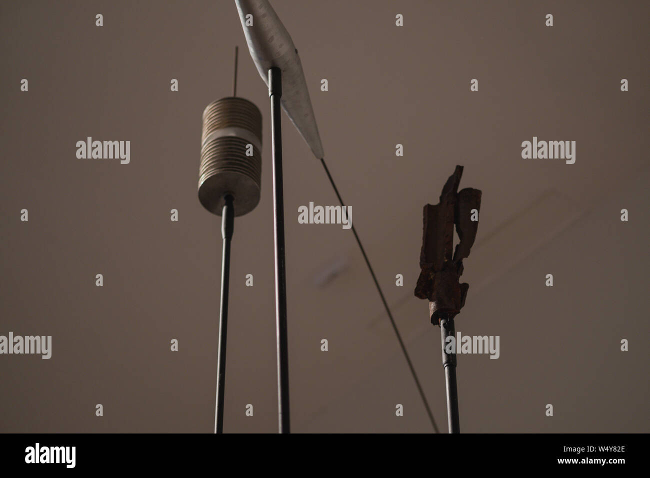 Metal sculptures dimly lit - Takis exhibition - Tate Modern - London ...