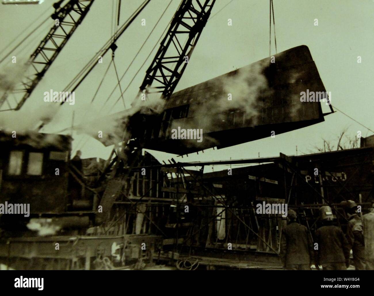 Crane swinging the hull section of a submarine chaser into place, 1942 ...