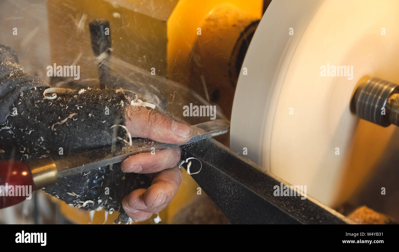 Carpenter handles wood by machine. Builder works with workpiece in ...