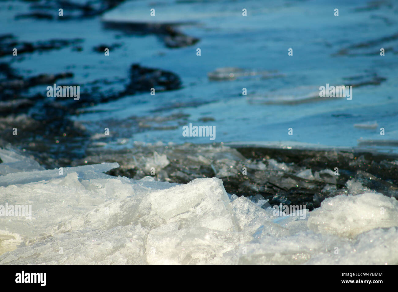 Chunks of ice floating on the river. White crystal surface on ...