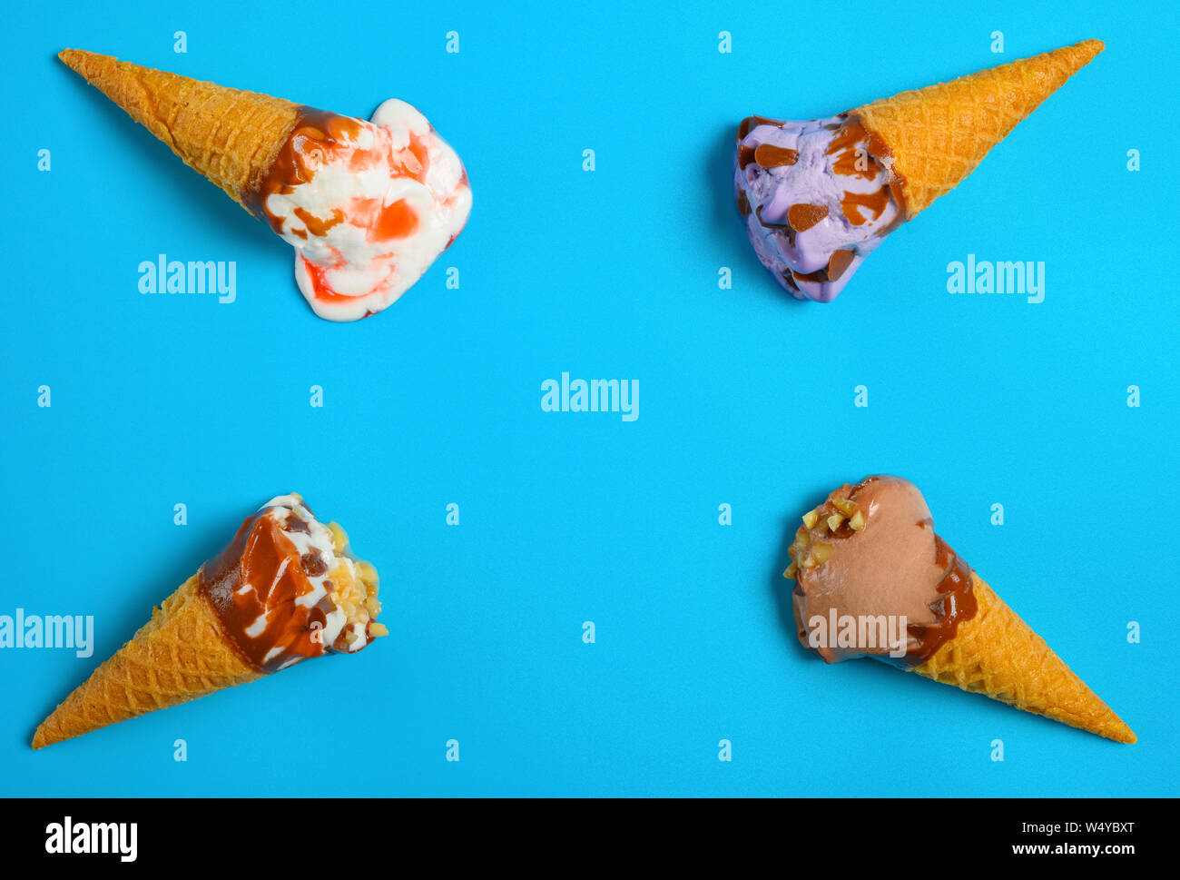 top view mini ice cream cones in a melting process on a blue background ...