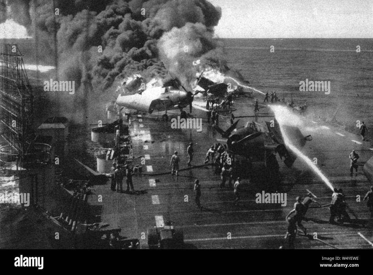 Crewmen fighting fires aboard USS Belleau Wood (CVL-24), on 30 October ...