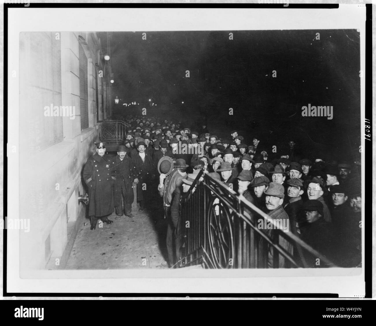 Crowd of men outside municipal lodging house, waiting for the doors to ...