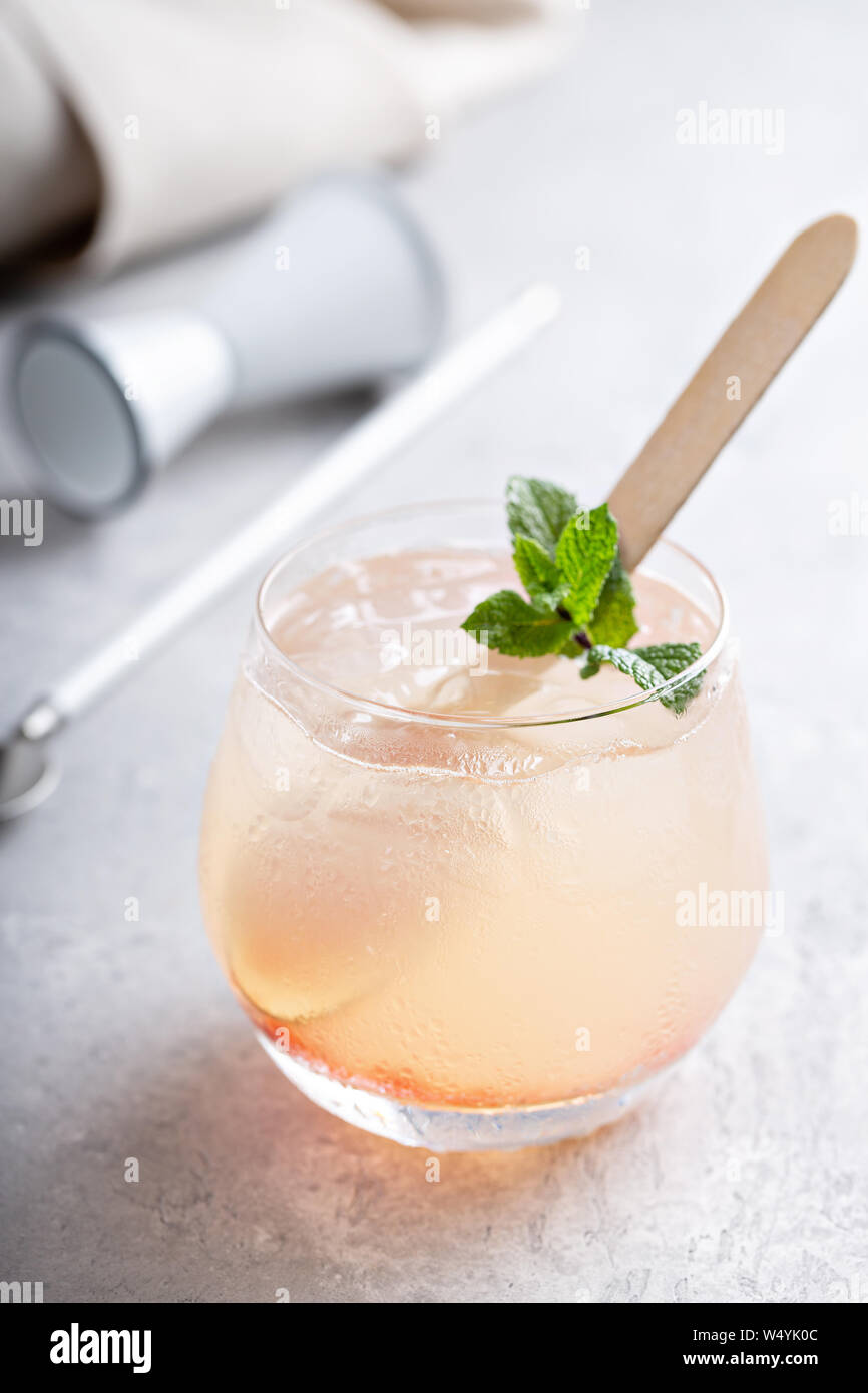 Peach alcoholic cocktail with jam on a spoon Stock Photo - Alamy