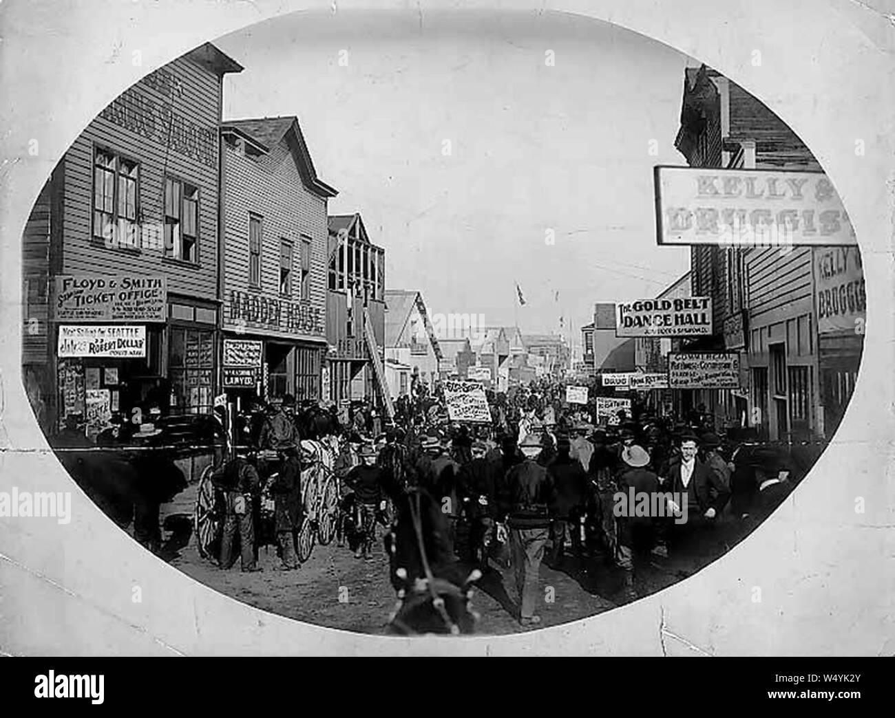 Crowded scene on Front Street showing the Gold Belt Dance Hall and ...