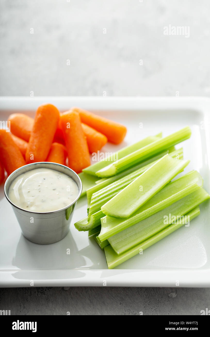 Celery and carrot sticks with ranch, healthy snack idea Stock Photo - Alamy