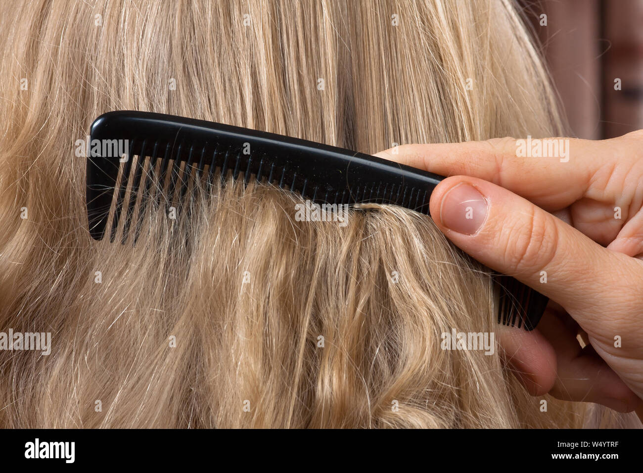 hand combing blonde long hair, close up Stock Photo - Alamy