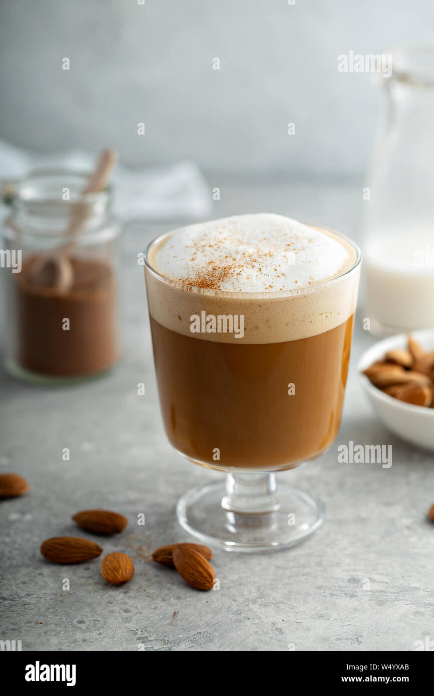 Almond milk latte with thick foam in a glass Stock Photo - Alamy