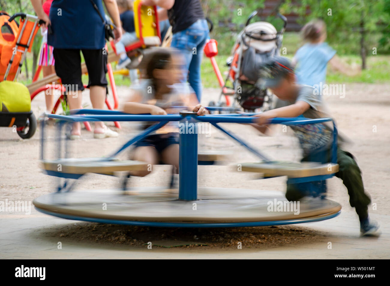 motion view of friendly children ride at the carousel, joyful kids ...
