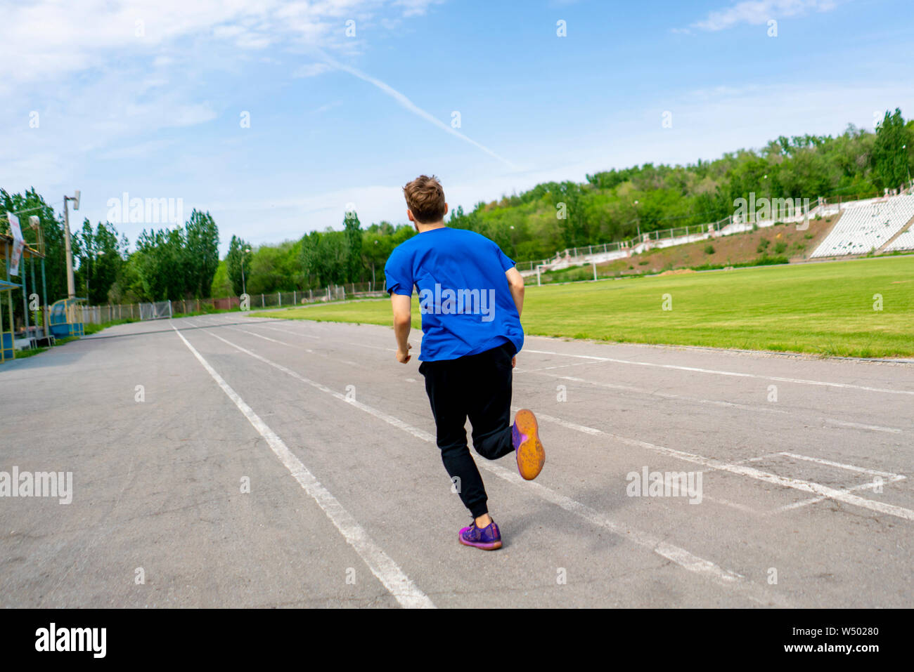 fast speed runner on the stadium sport track outdoor before the ...