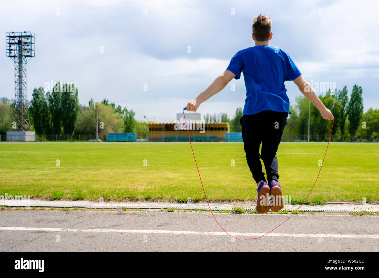 male athlete sportsman practice with jump rope at the outdoor stadium ...