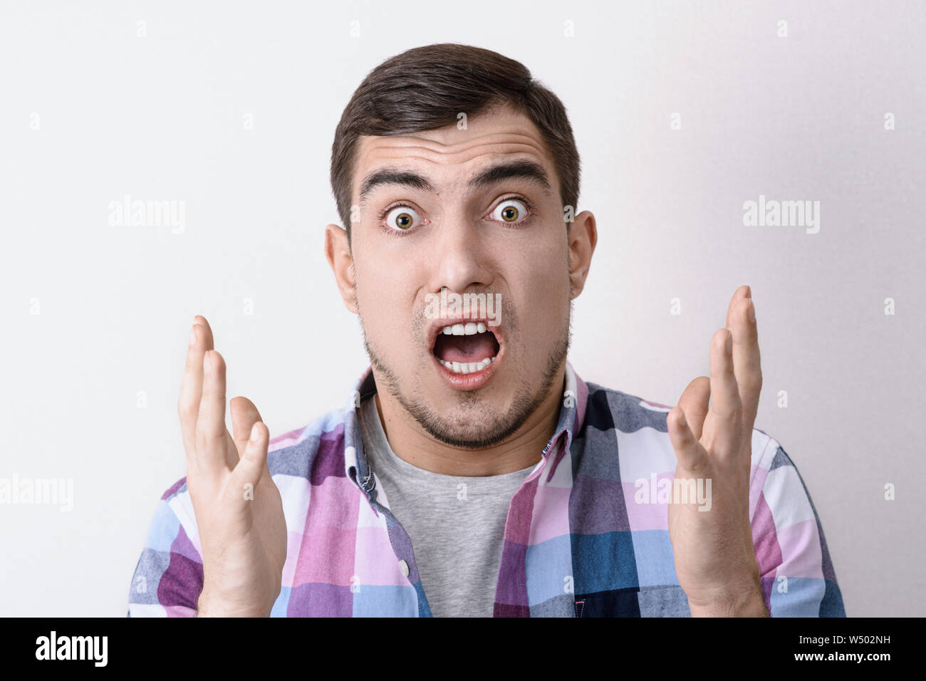 Close-up portrait of Caucasian shocked man, with open mouth, raised ...