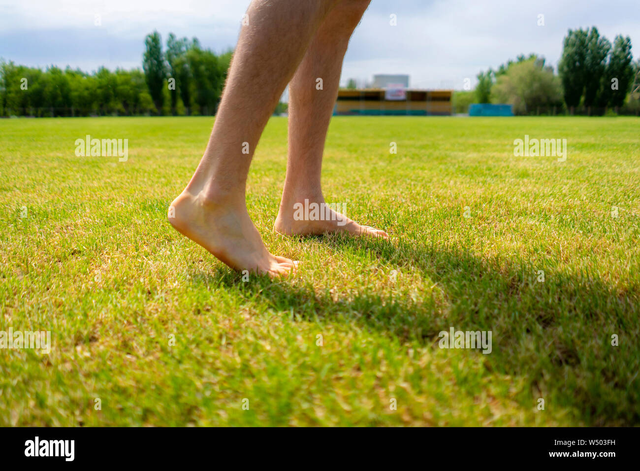 bare feet walking on the lawn grass field, healthy lifestyle practice ...