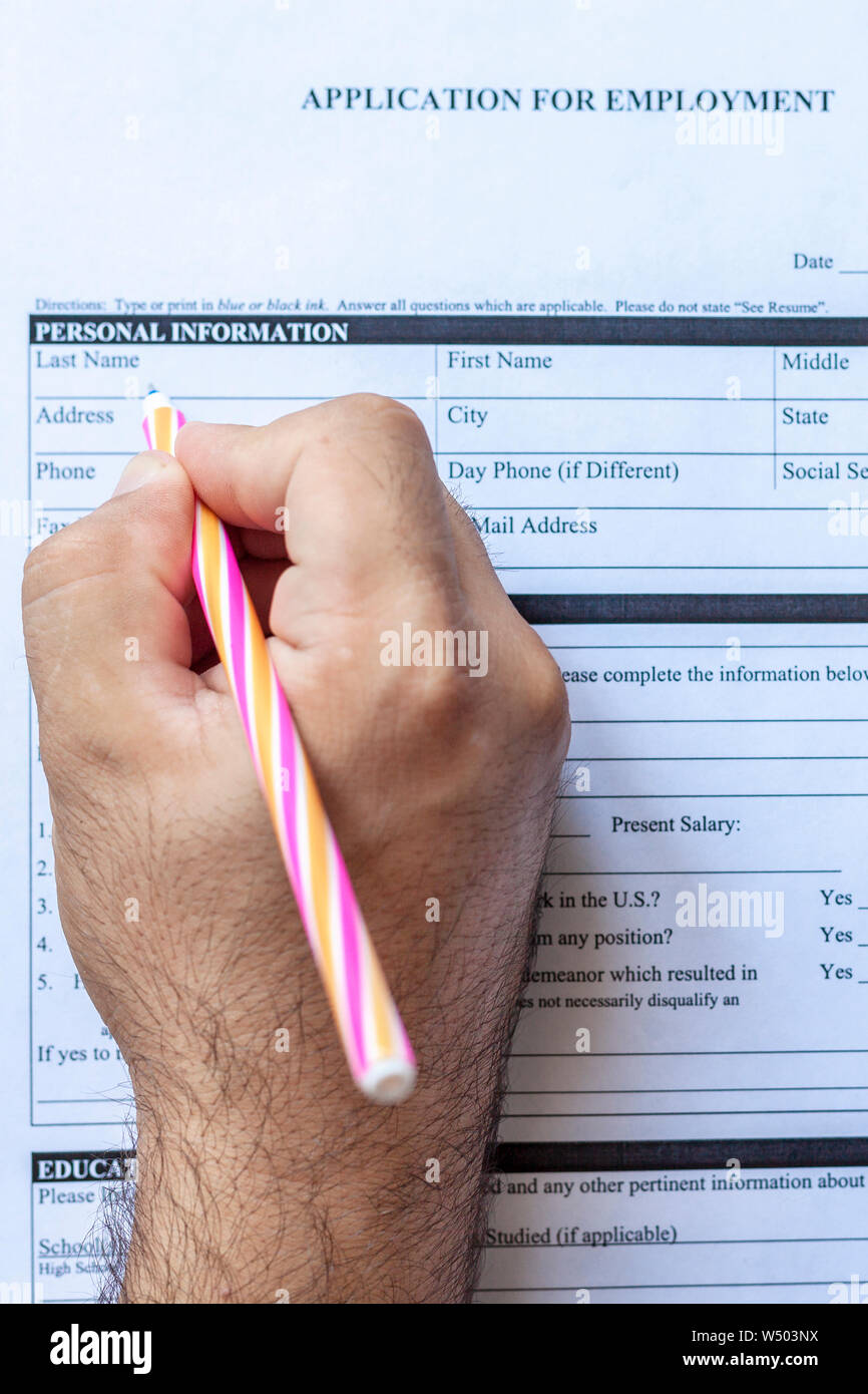 Hand filling Standard Application for Employment. HR, Hiring, Applicant ...