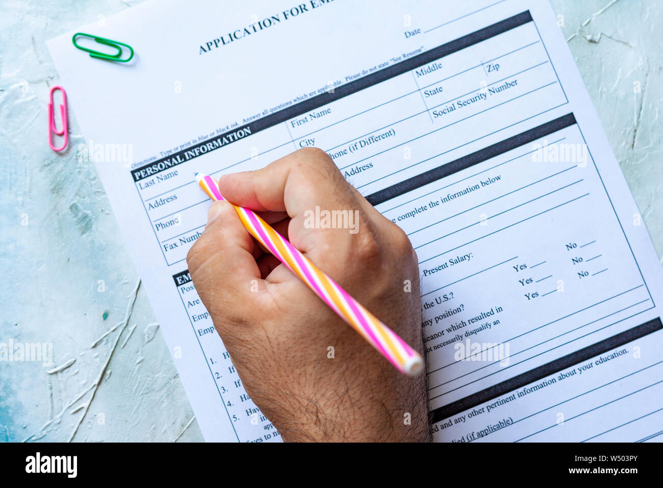 Hand filling Standard Application for Employment. HR, Hiring, Applicant ...